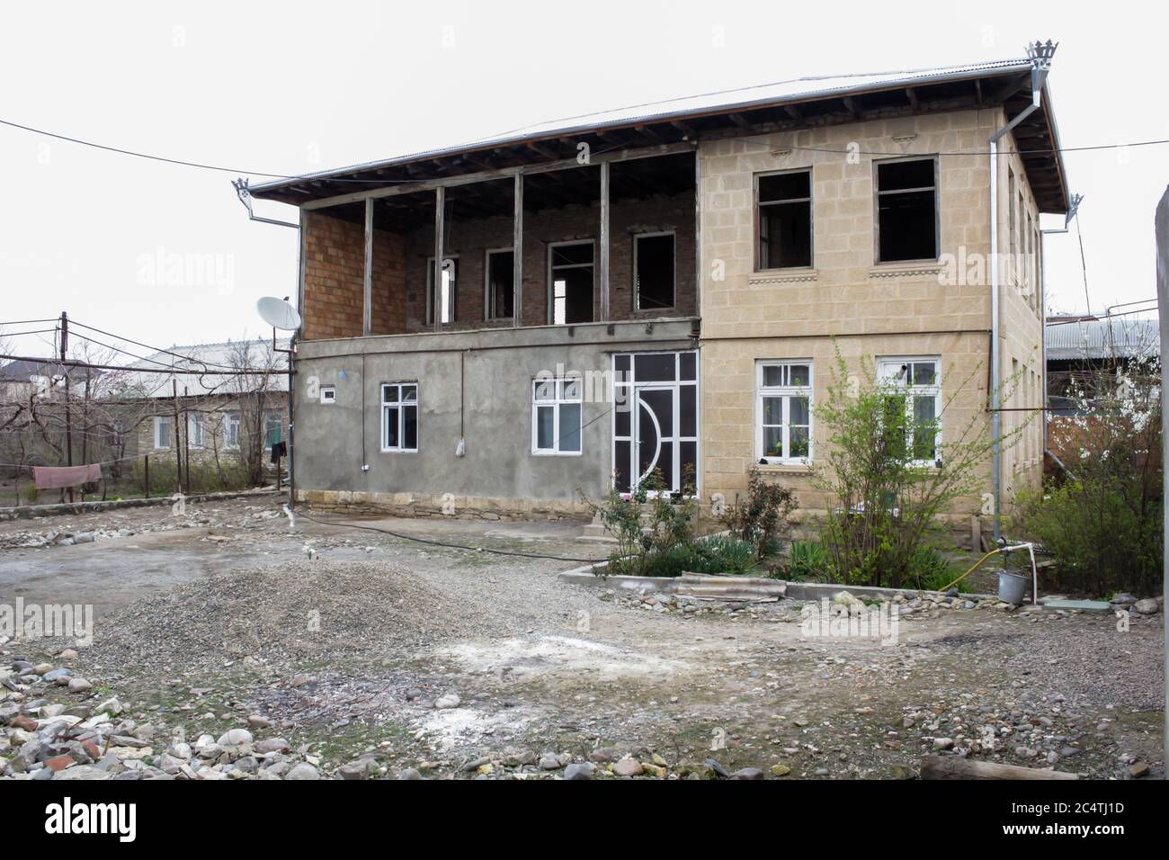 Old village with old gray houses and dry bare trees Stock Photo - Alamy