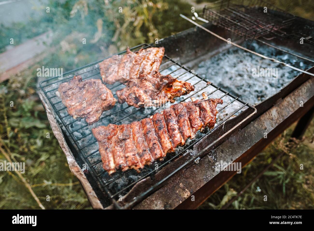 Cooking pork ribs on the grill Stock Photo - Alamy