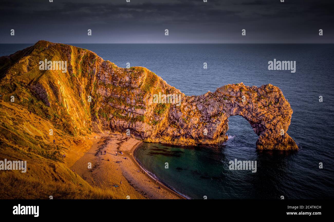 Sunset over Durdle Door - the most famous landmark in Devon England ...