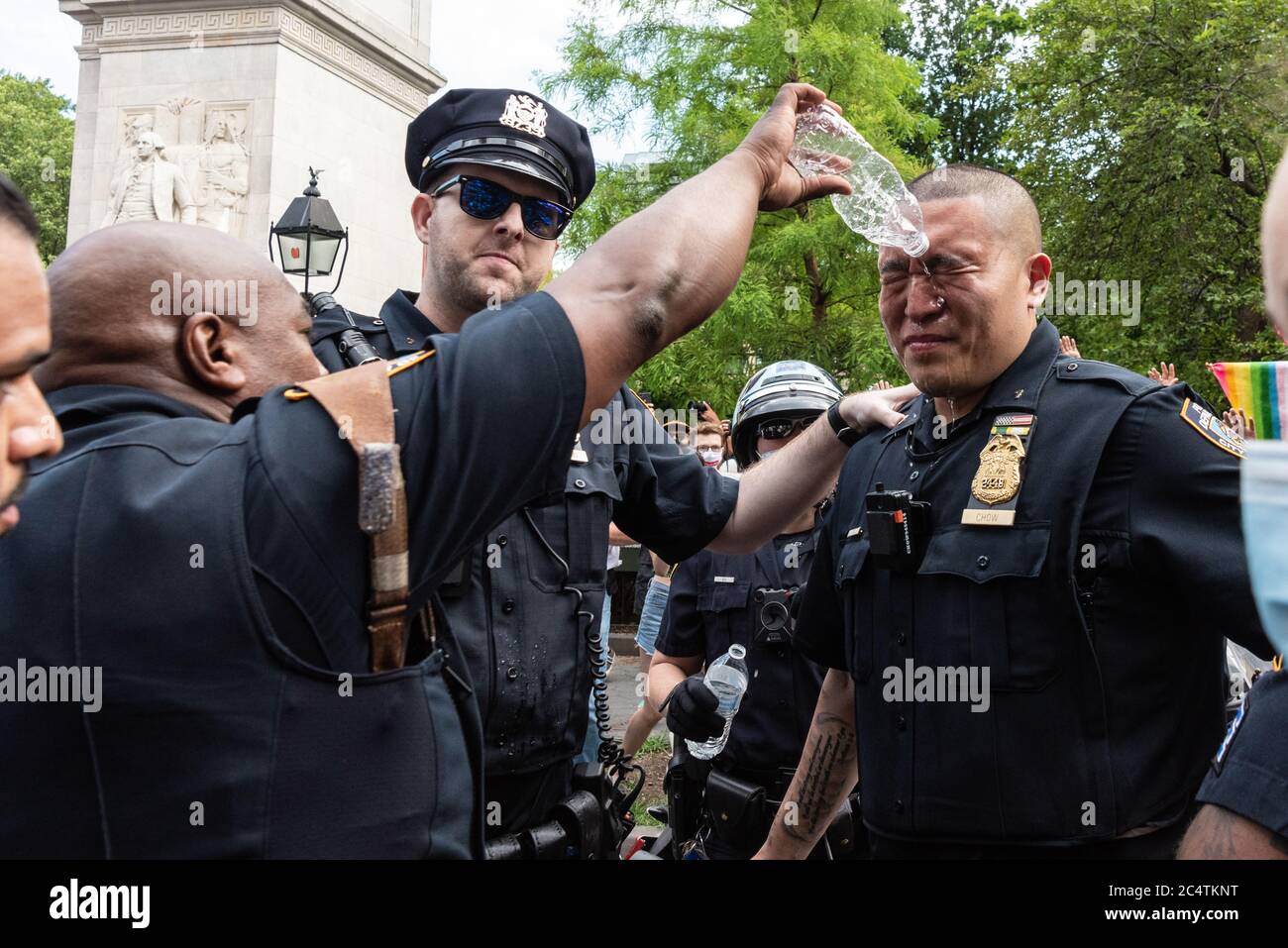 NYPD officers assist their collegue after a pepper spray incident at ...