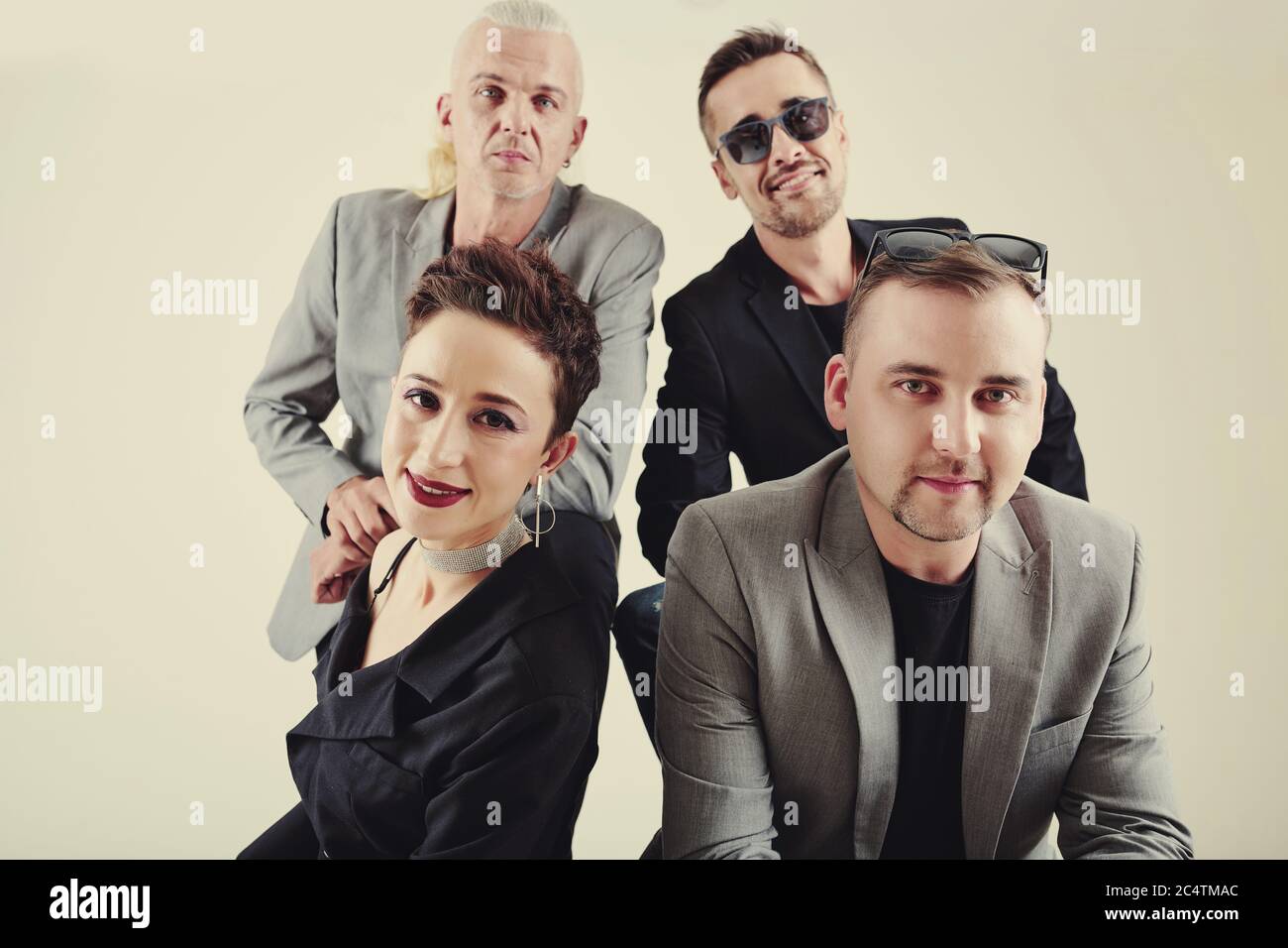 Positive musicians and singers posing for photo after performing in ...