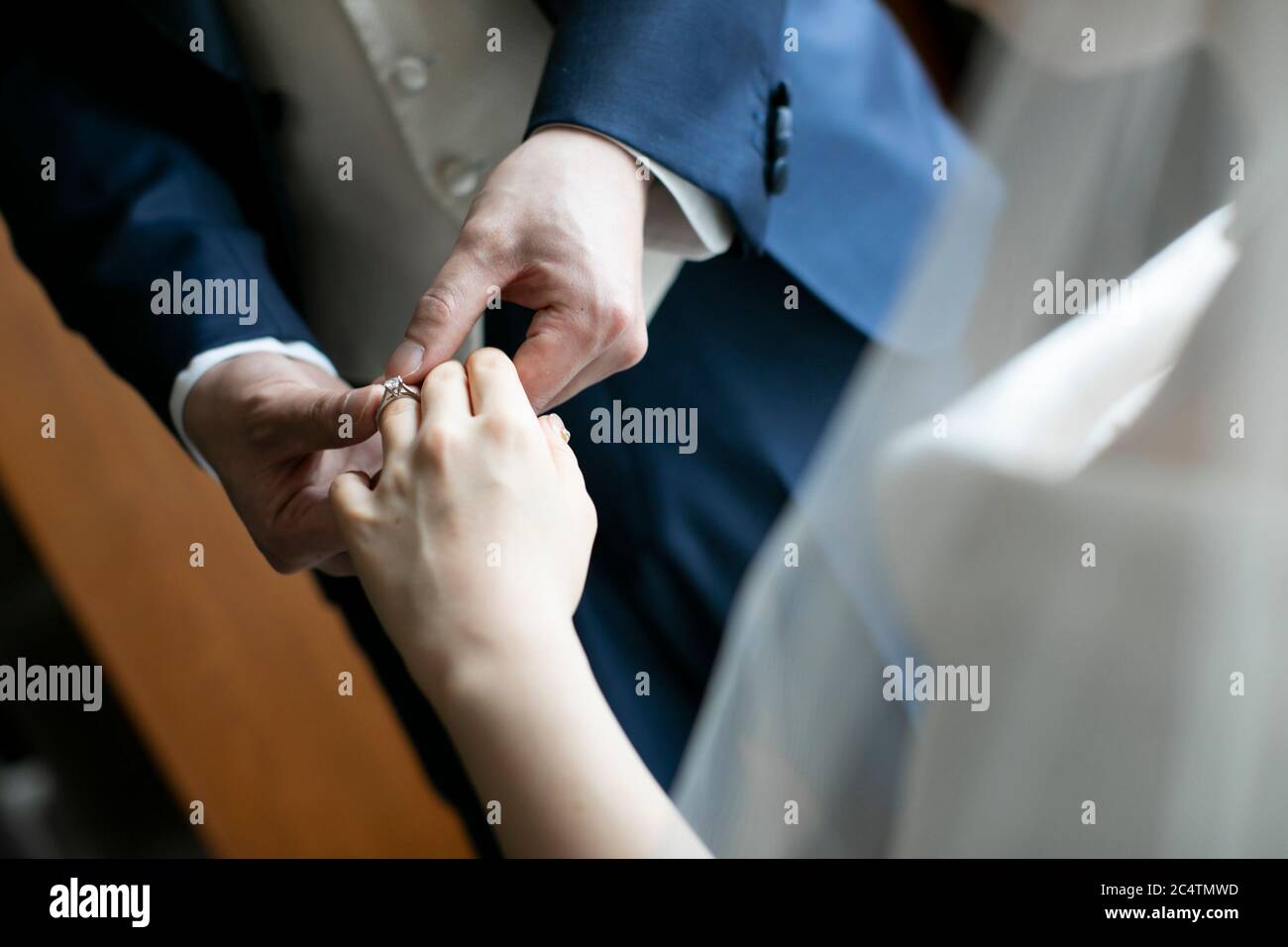 Placing a wedding ring on finger Stock Photo - Alamy