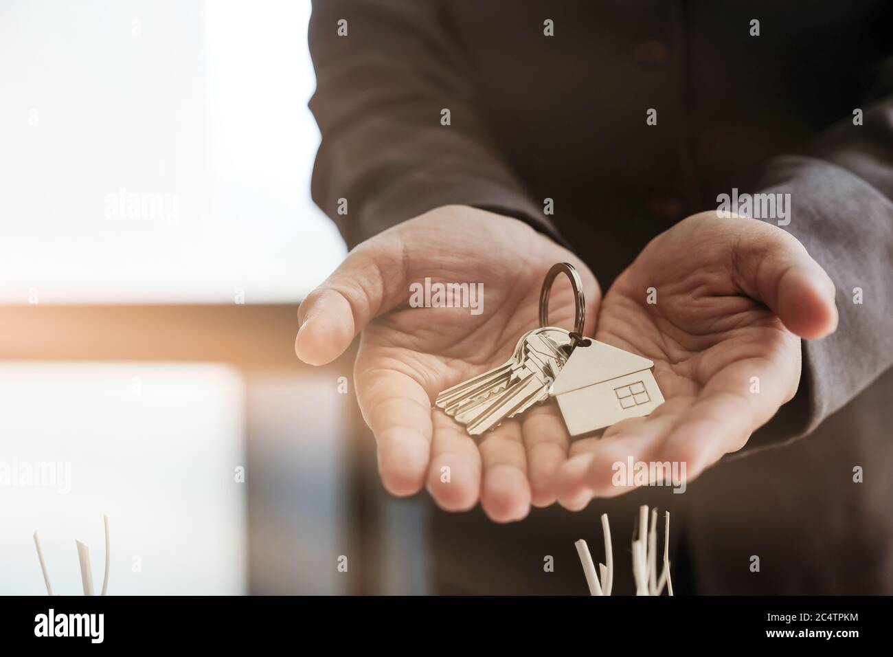 Real estate agent handing over house keys with approved mortgage ...
