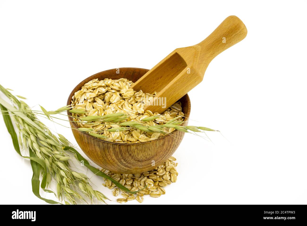 Oat flakes in the bowl, wooden scoop and oat branch isolated on white ...