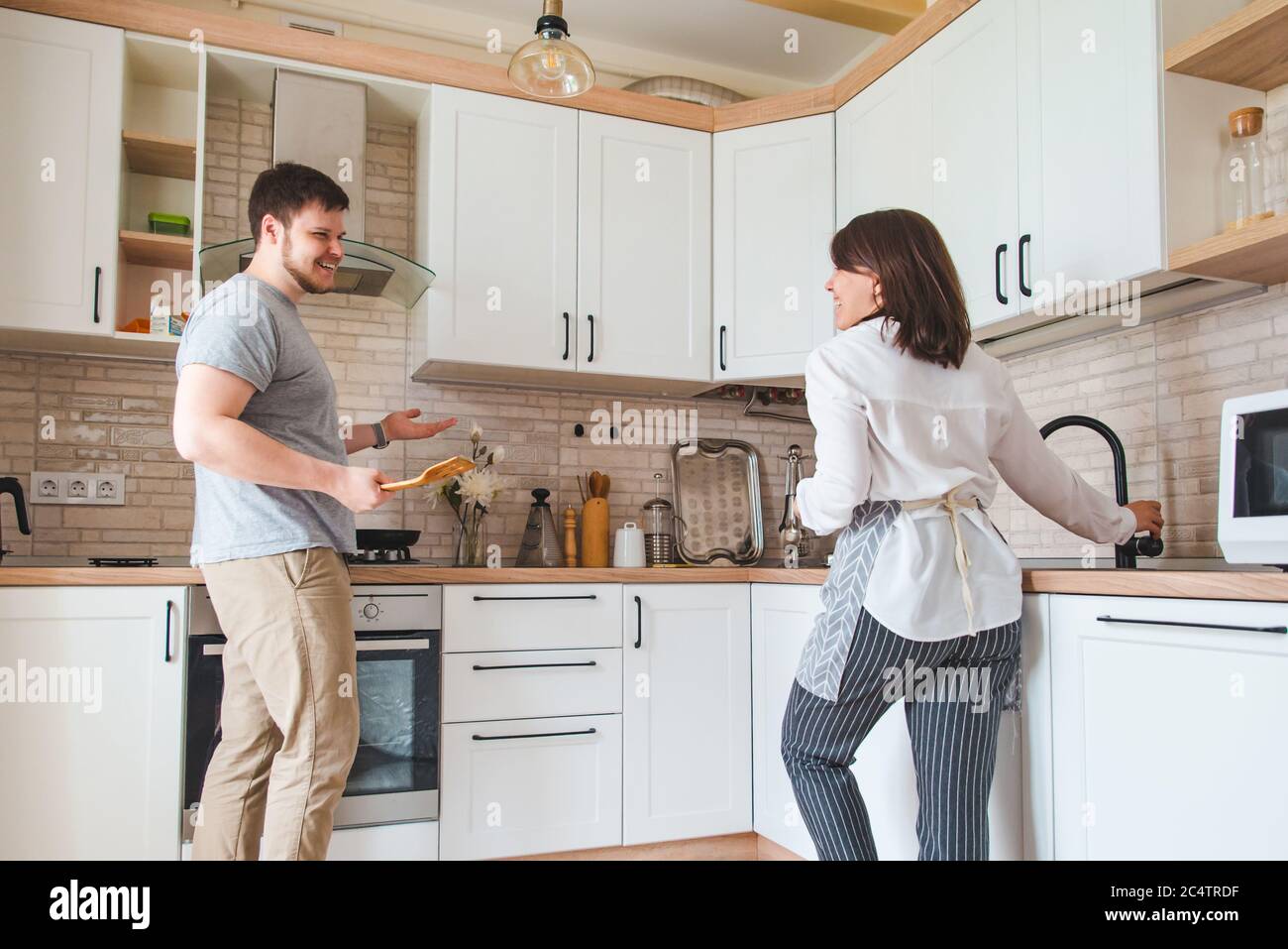 couple cooking on kitchen washing dishes Stock Photo - Alamy