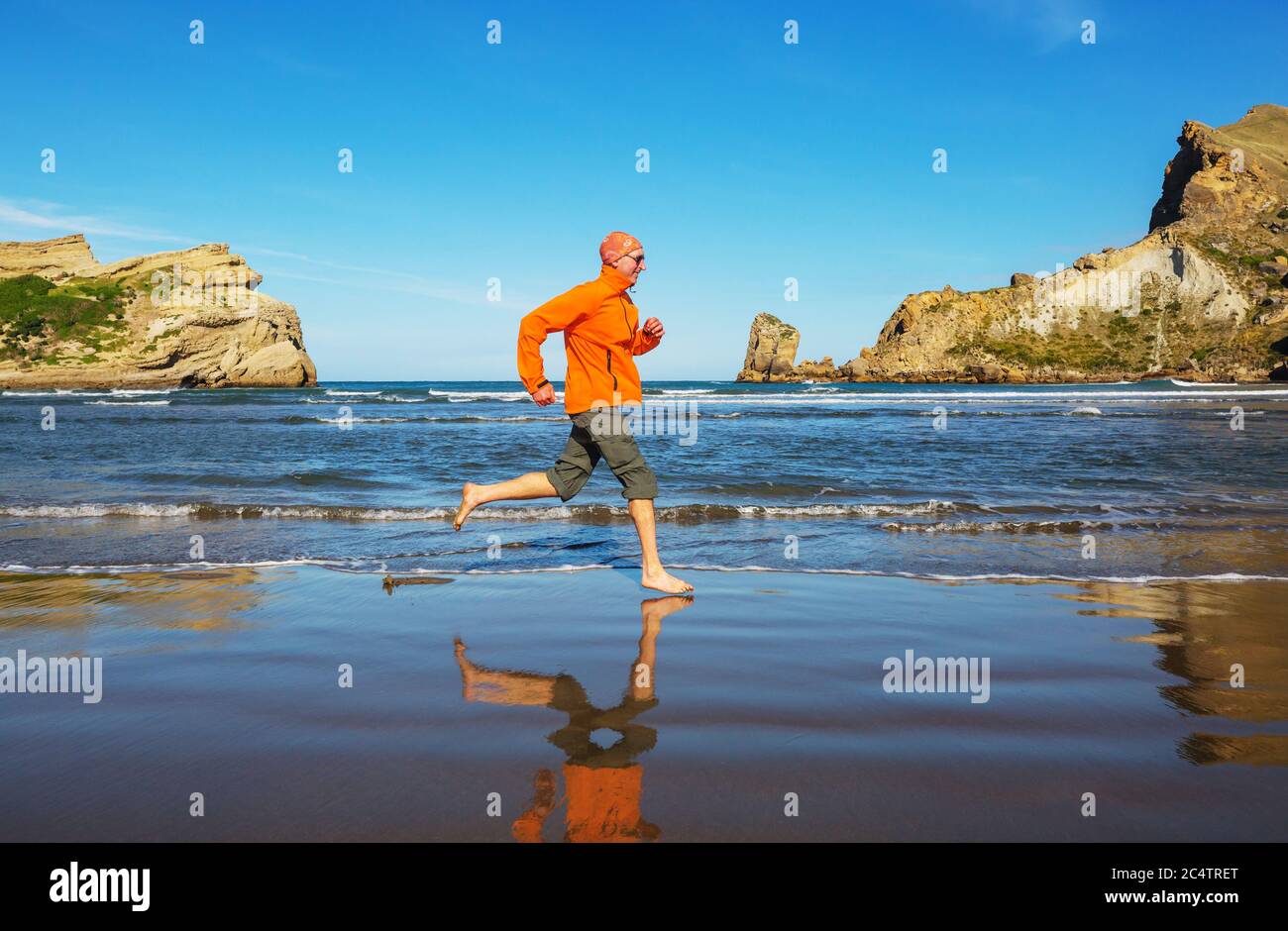 Running man in ocean coast Stock Photo - Alamy