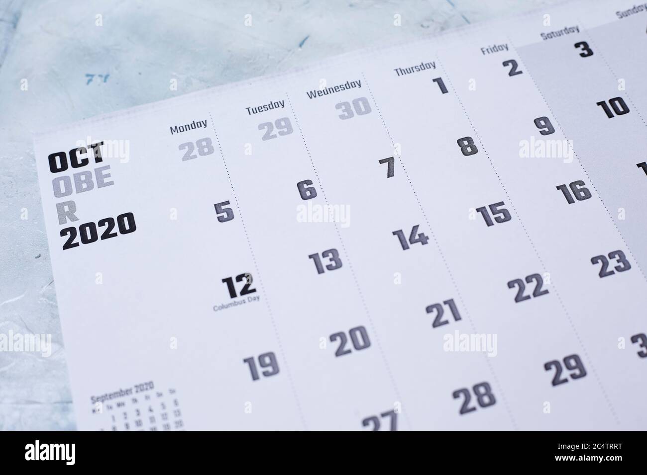 Simple 2020 October monthly calendar on table with office supplies ...