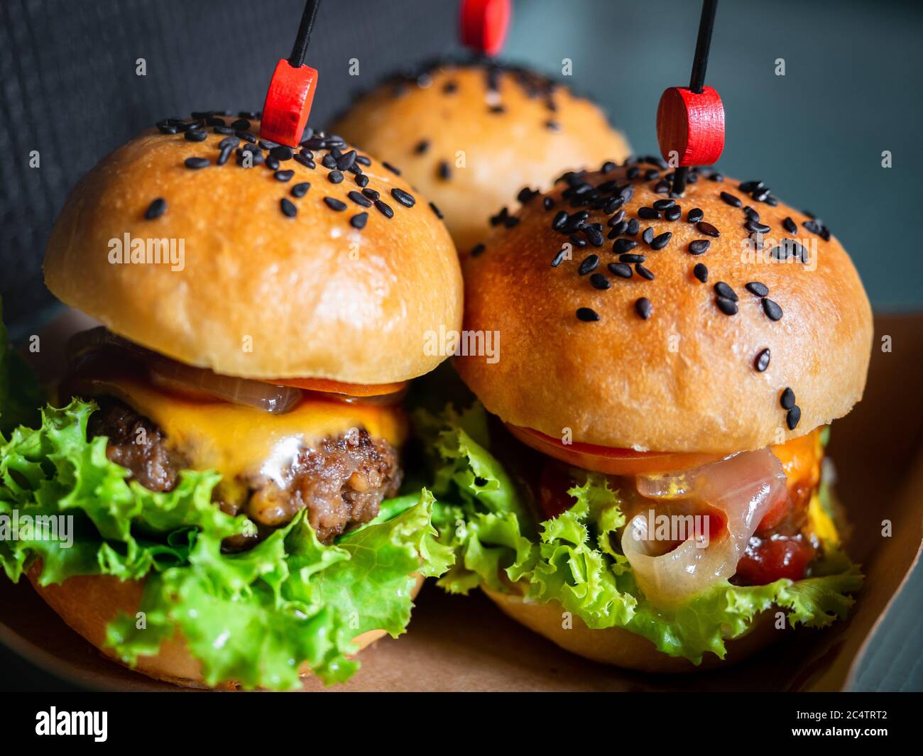 Homemade burger ready to eat. Close-up mini homemade juicy burgers with ...