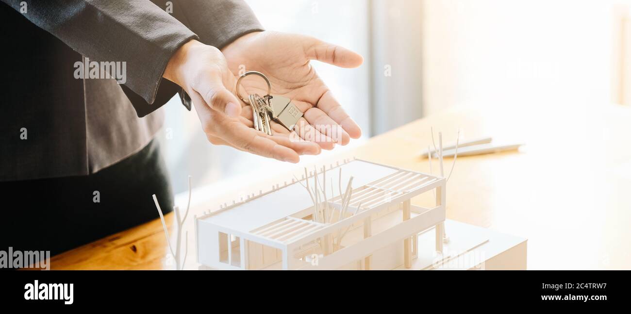 Real estate agent giving house keys hi-res stock photography and images ...