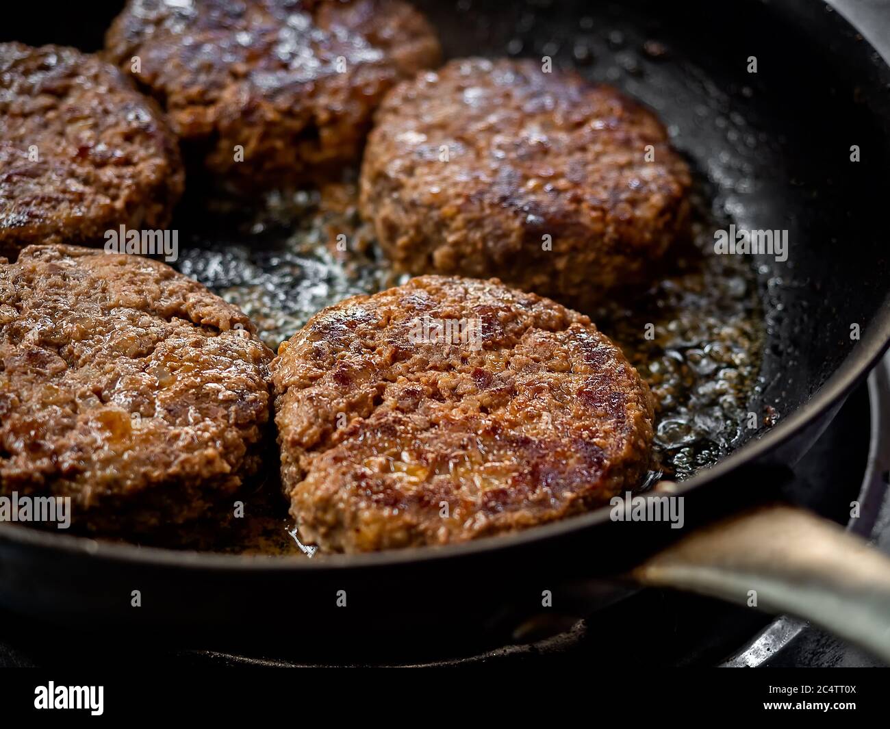 Beef burgers fried in frying pan. Close-up homemade juicy minced meat ...