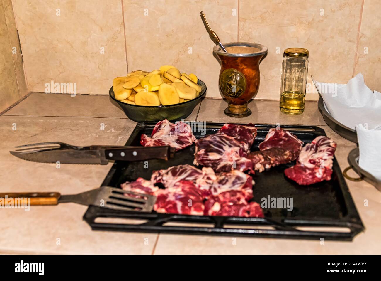Different types of raw meat on the tables. On the rustic background ...