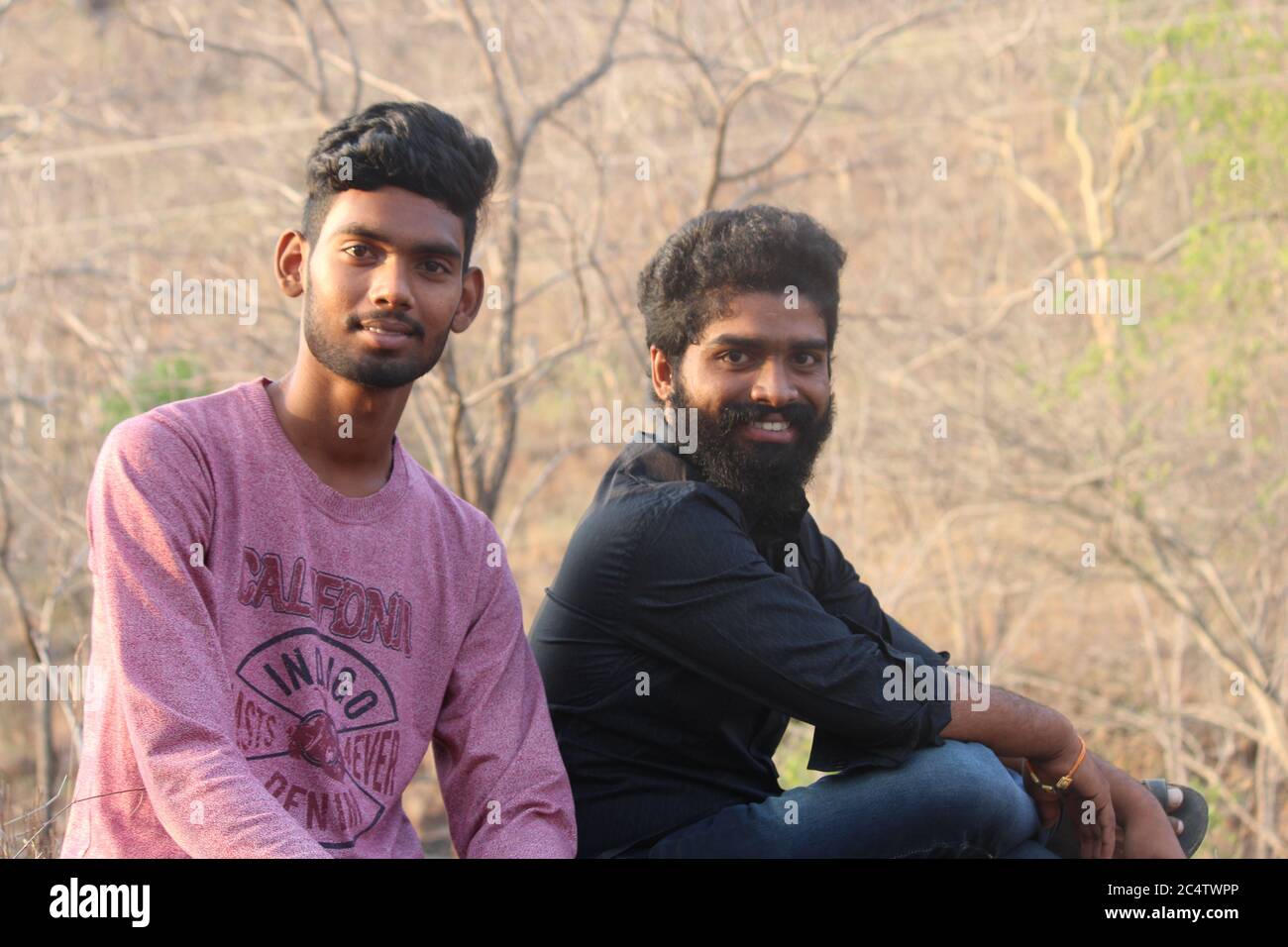 Portrait of two friends smiling at camera,over background as portrait ...