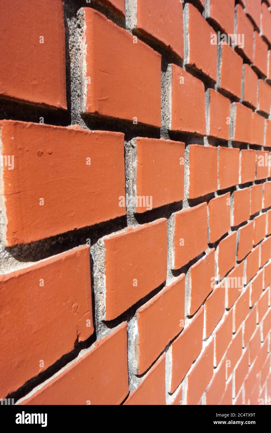 Bred brick wall background with diminishing brick size Stock Photo - Alamy