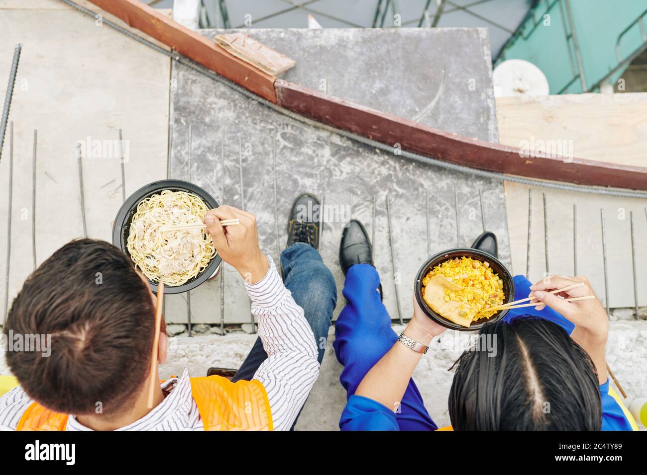 Workers having delicious dishes for lunch right at construction site ...