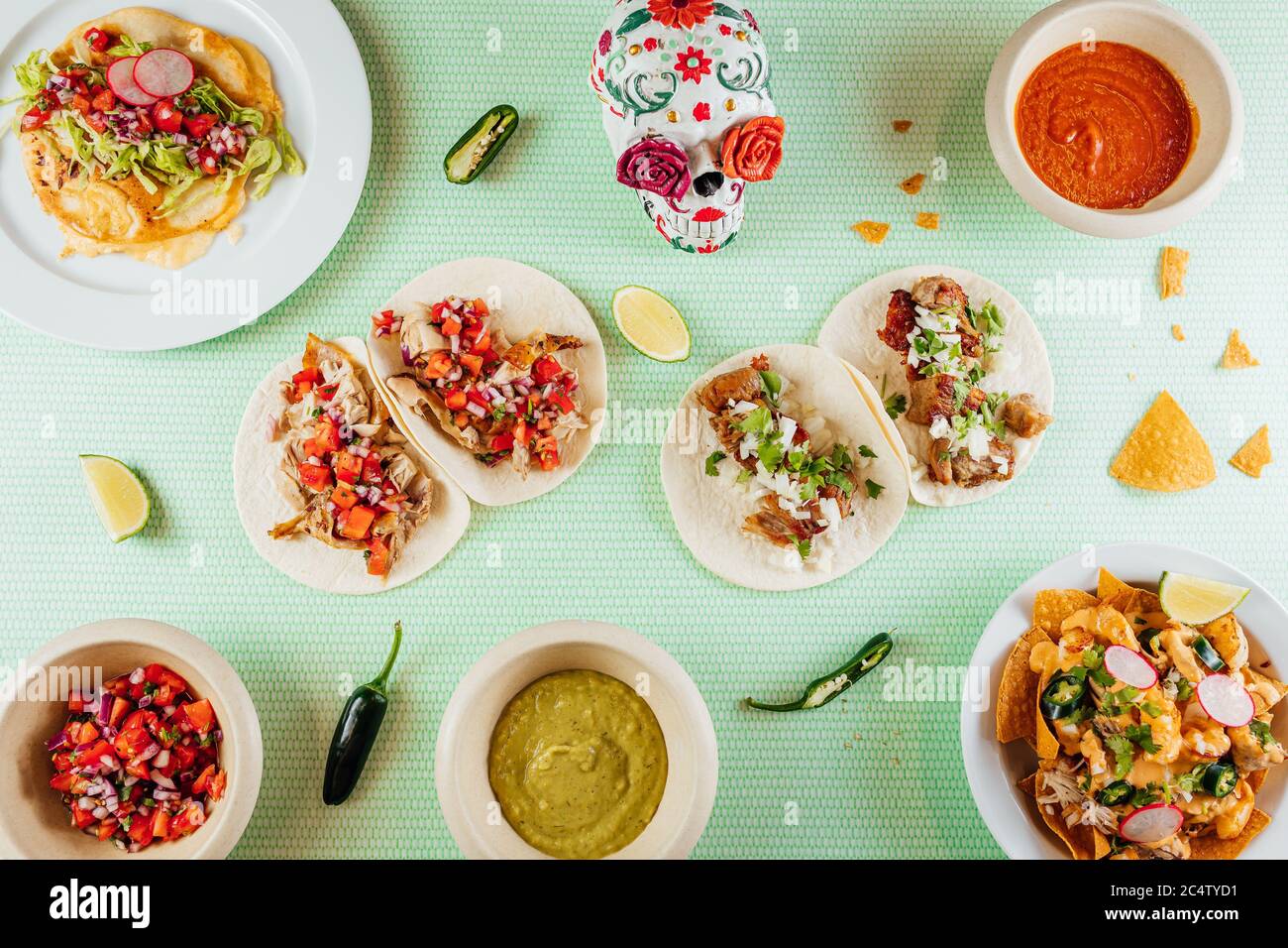 Top view of tortilla wraps surrounded with different dishes on a table ...