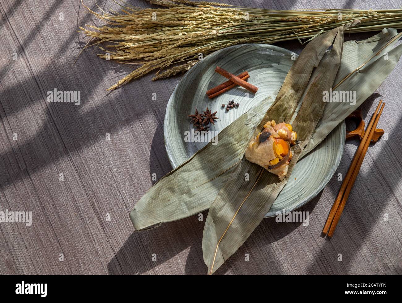 Chinese rice dumpling (Zongzi) shaped pyramidal wrapped by leaves ...