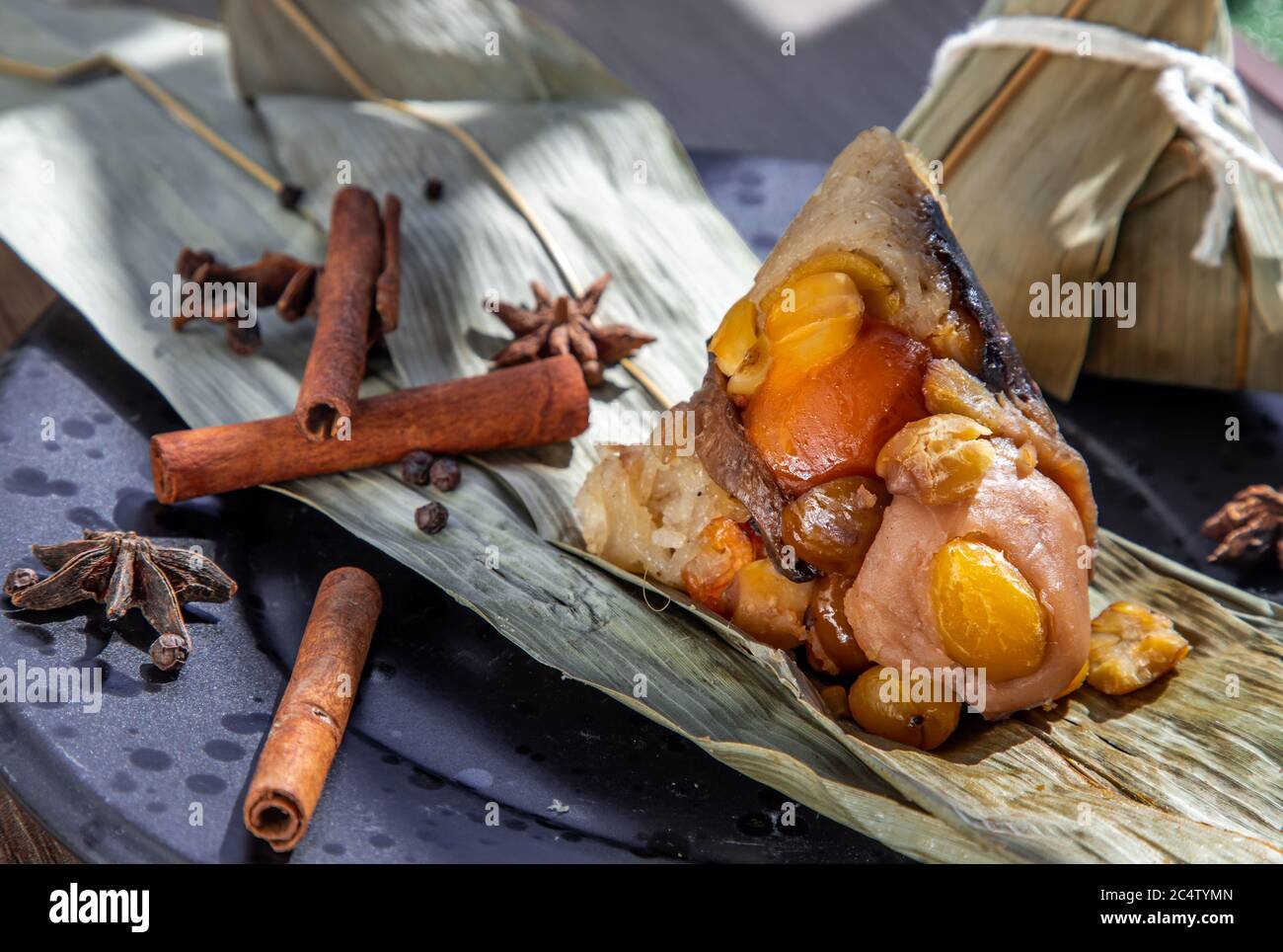 Chinese rice dumpling (Zongzi) shaped pyramidal wrapped by leaves ...