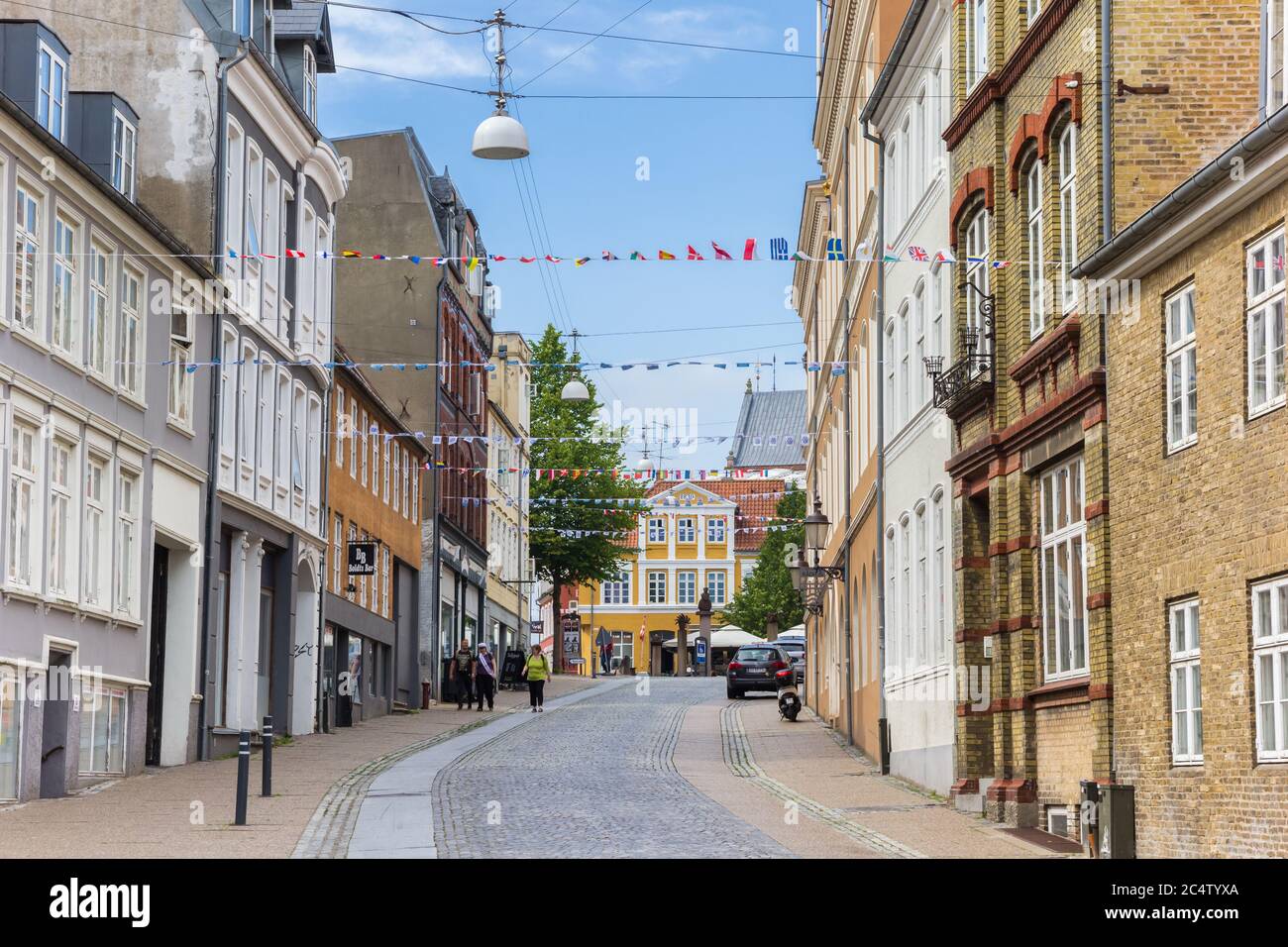Historic houses and little flags in the center of Haderslev, Denmark ...