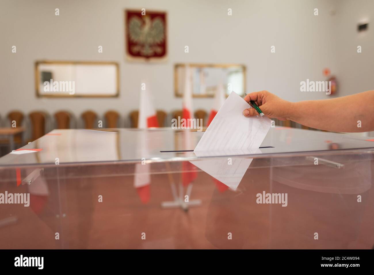 Throwing a card with a vote to the ballot box during elections. In the ...