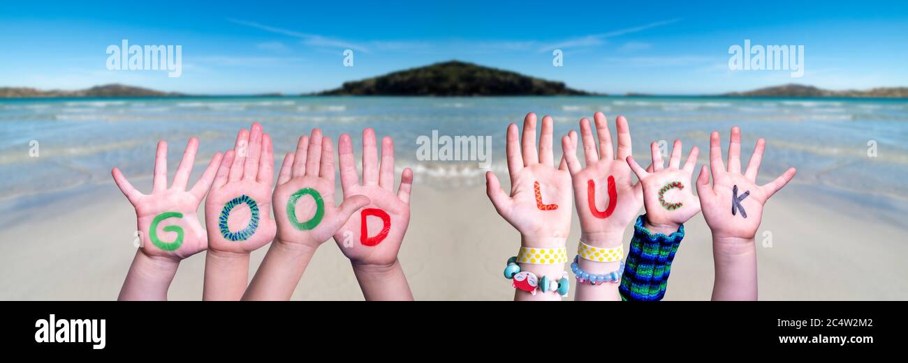 Kids Hands Holding Word Good Luck, Ocean Background Stock Photo - Alamy