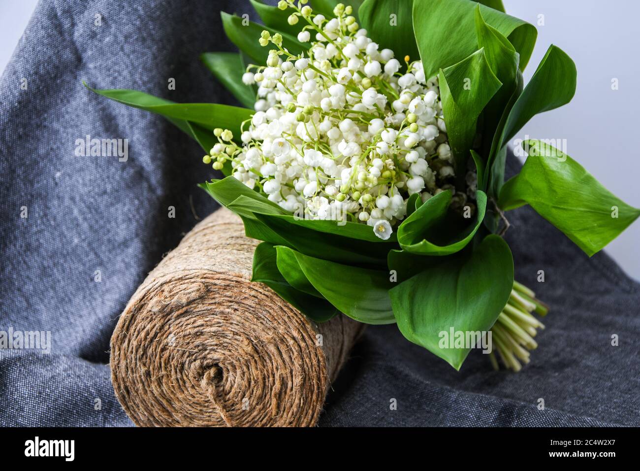 Spring bouquet of lilies of the valley with rope in a flower shop Stock ...