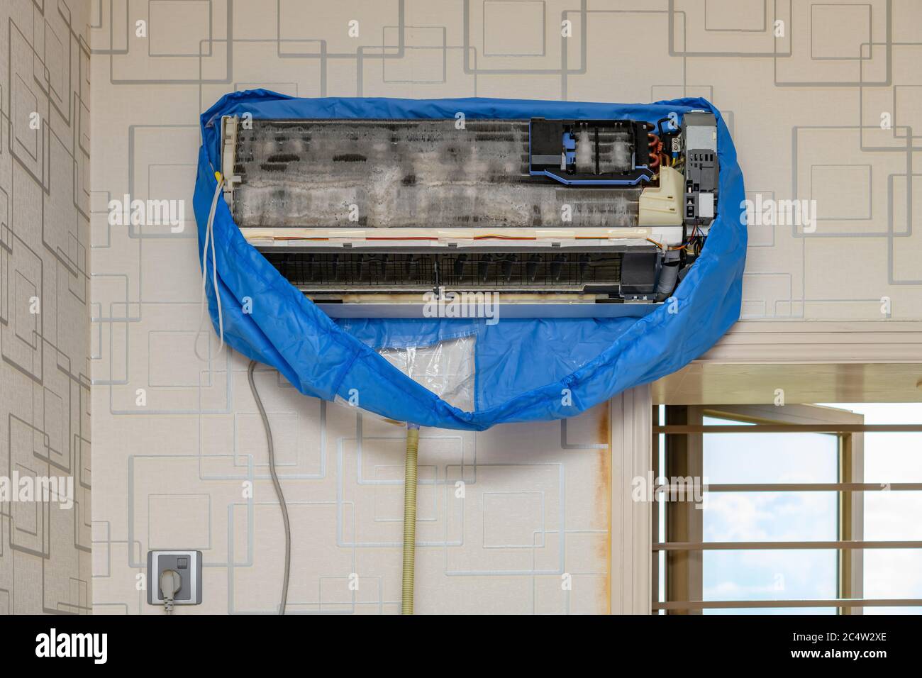 cleaning the air conditioner with chemical liquid Stock Photo - Alamy