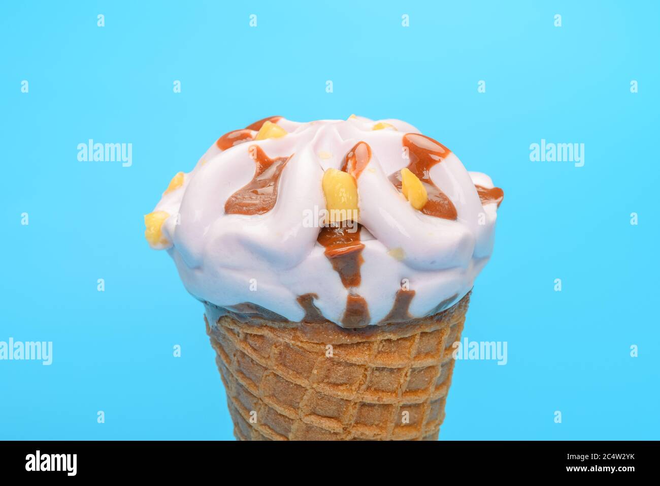 sweet potato flavor ice cream cone in a melting process on blue ...