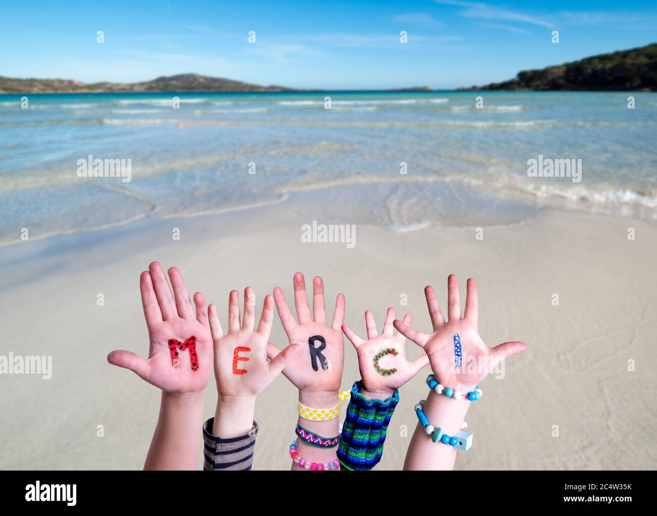 Children Hands Building Word Merci Means Thank You, Ocean Background ...