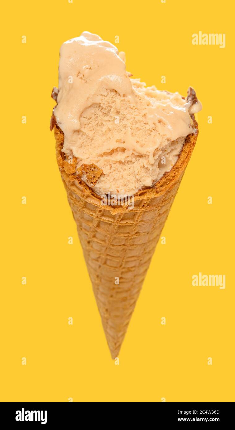 Angle View Milk Tea Flavor Ice Cream Cone With Some Bites On A Yellow