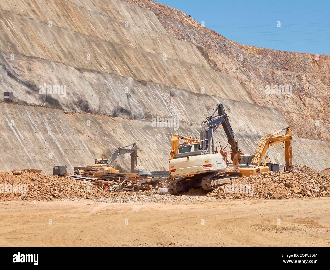 Excavator and hydrohammer during quarrying on the rocky soils. Heavy ...
