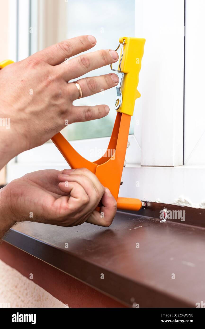 Construction work - installation of rivets. Window tint repair. Plastic ...