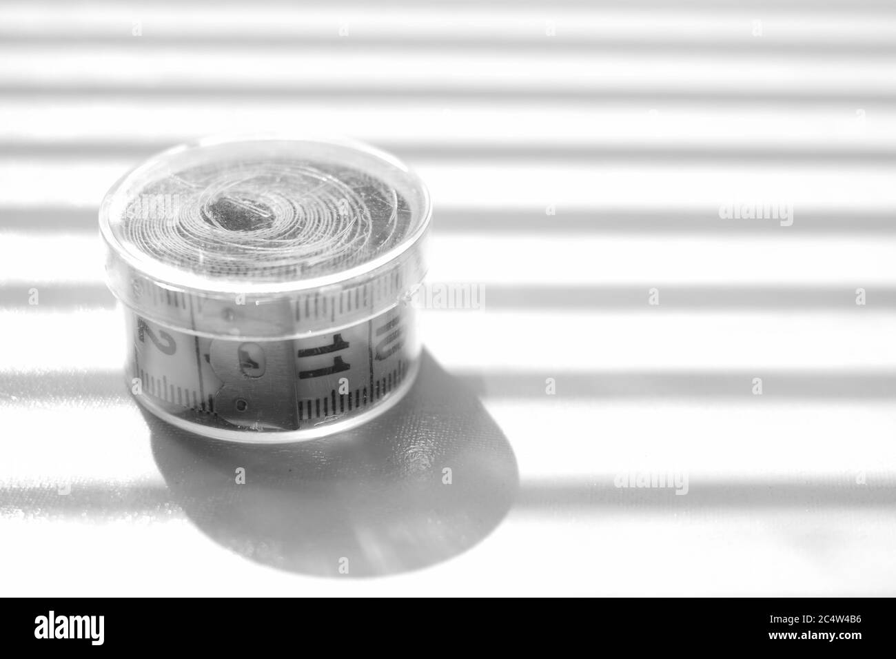 Measuring tape on the shiny table. BW photo Stock Photo - Alamy