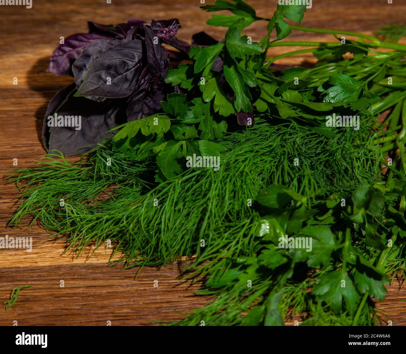 fresh blue basil, cilantro, dill on oak wood background Stock Photo - Alamy