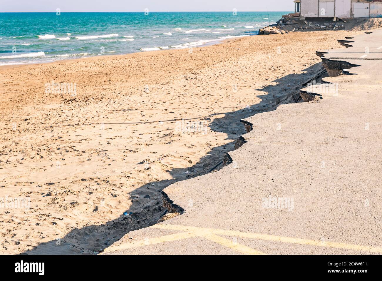 asphalt of the road cut by the waves in a sea storm Stock Photo - Alamy
