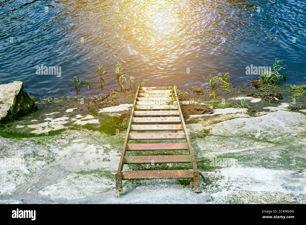 ramp on rocky riverbank descending to the river Stock Photo - Alamy