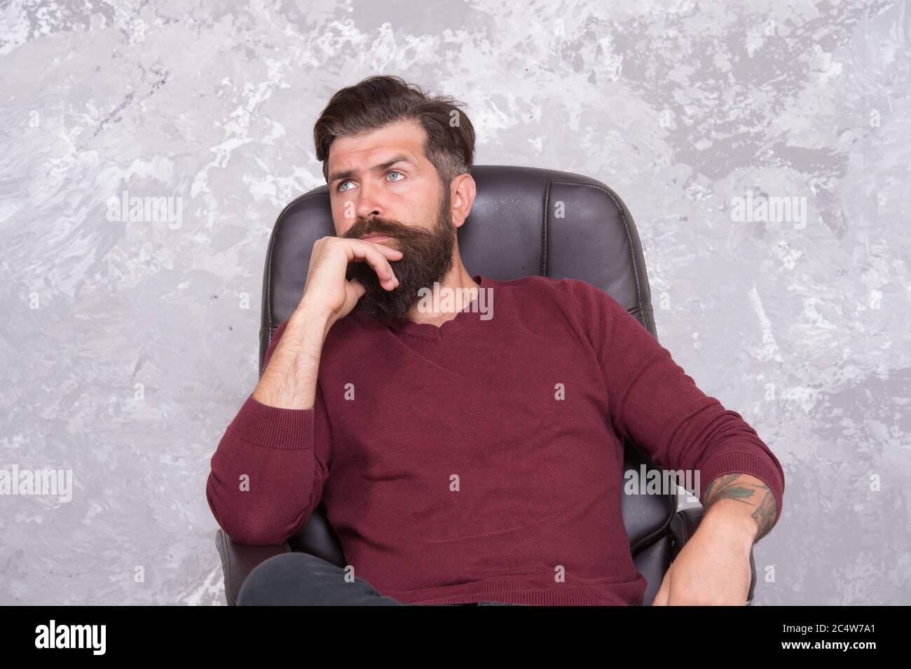 Thinking on serious problem. Serious hipster relax in chair. Serious ...