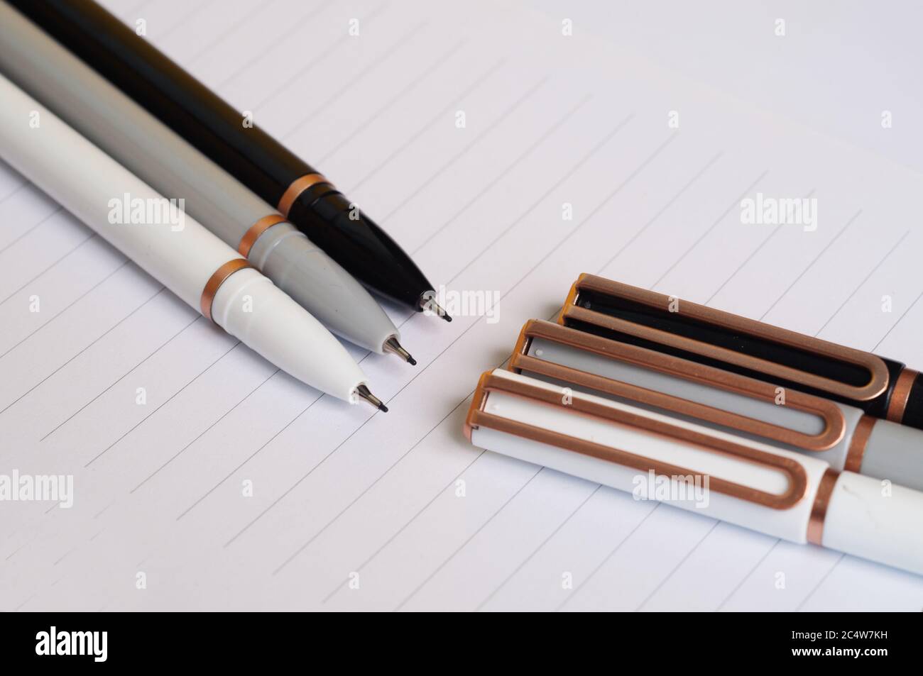 Colorful pens on a sheet of a notebook Stock Photo - Alamy