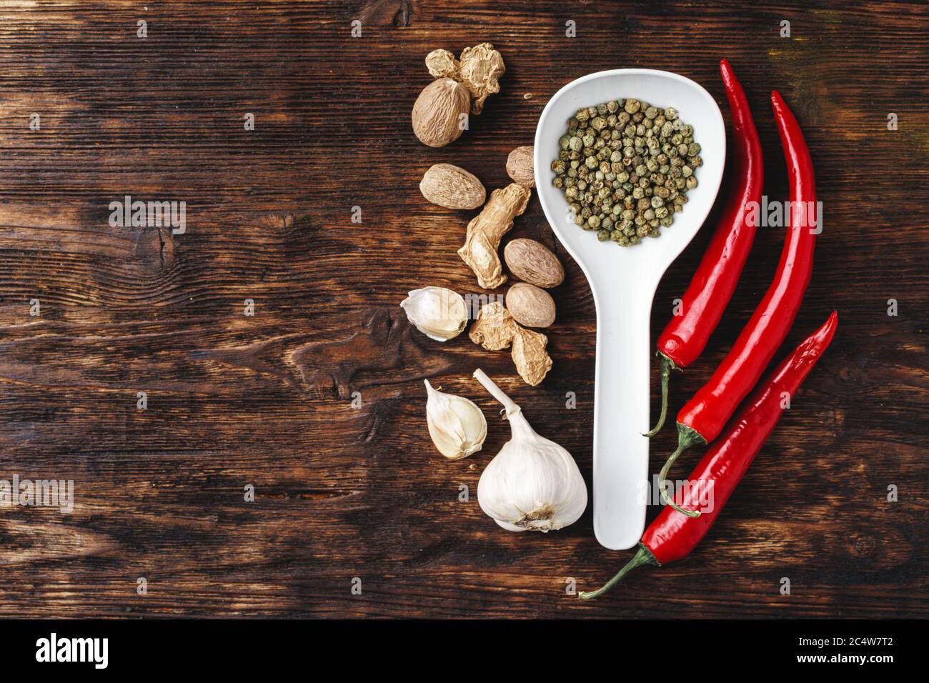 Top view of chili pepper, garlic and herbs on dark wooden surface Stock ...