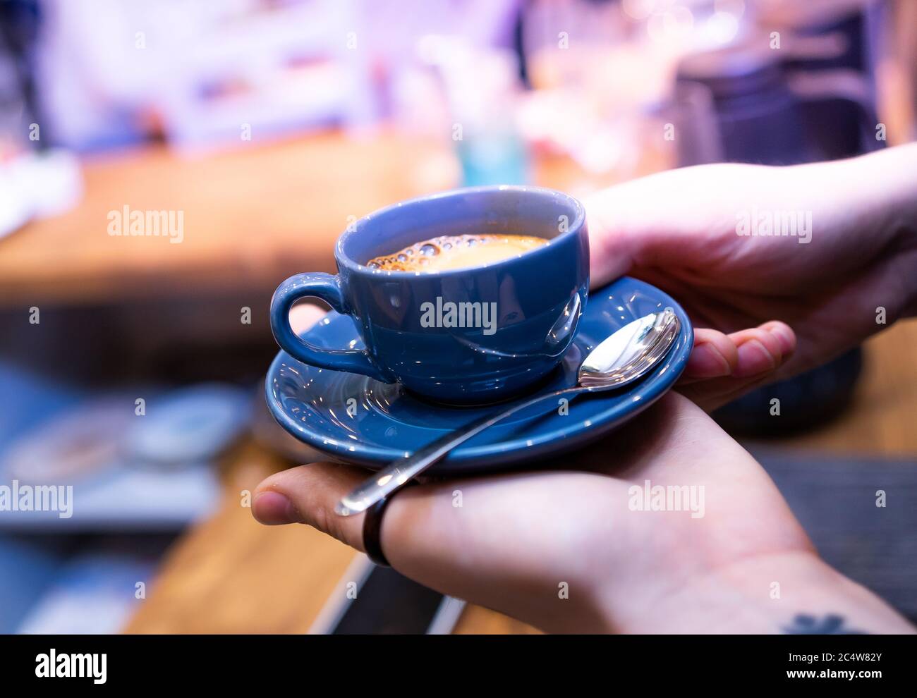 Cup of hot cappucino coffee on the wooden table. Early morning ...