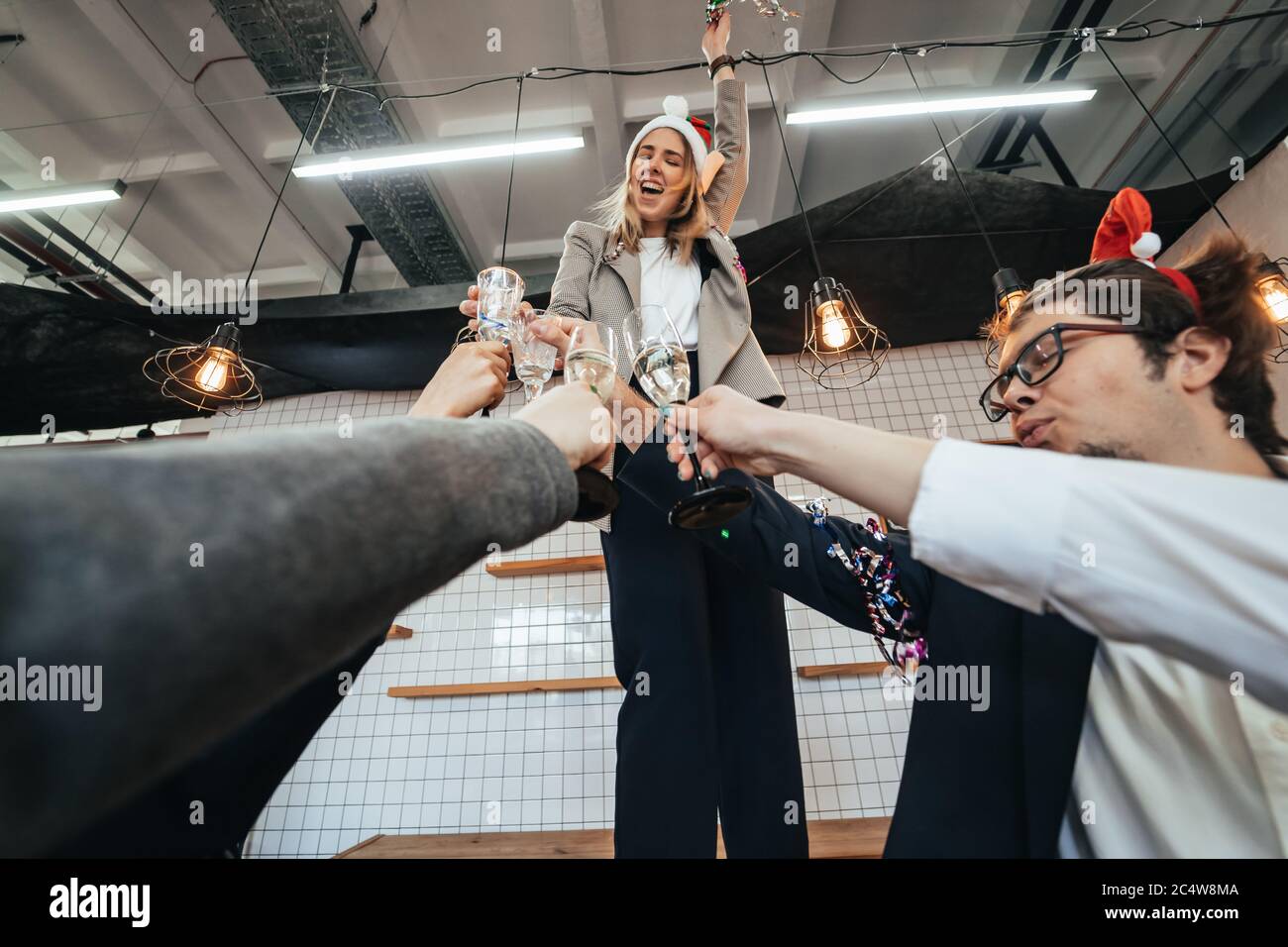 Happy colleagues in office celebrate special event Stock Photo - Alamy