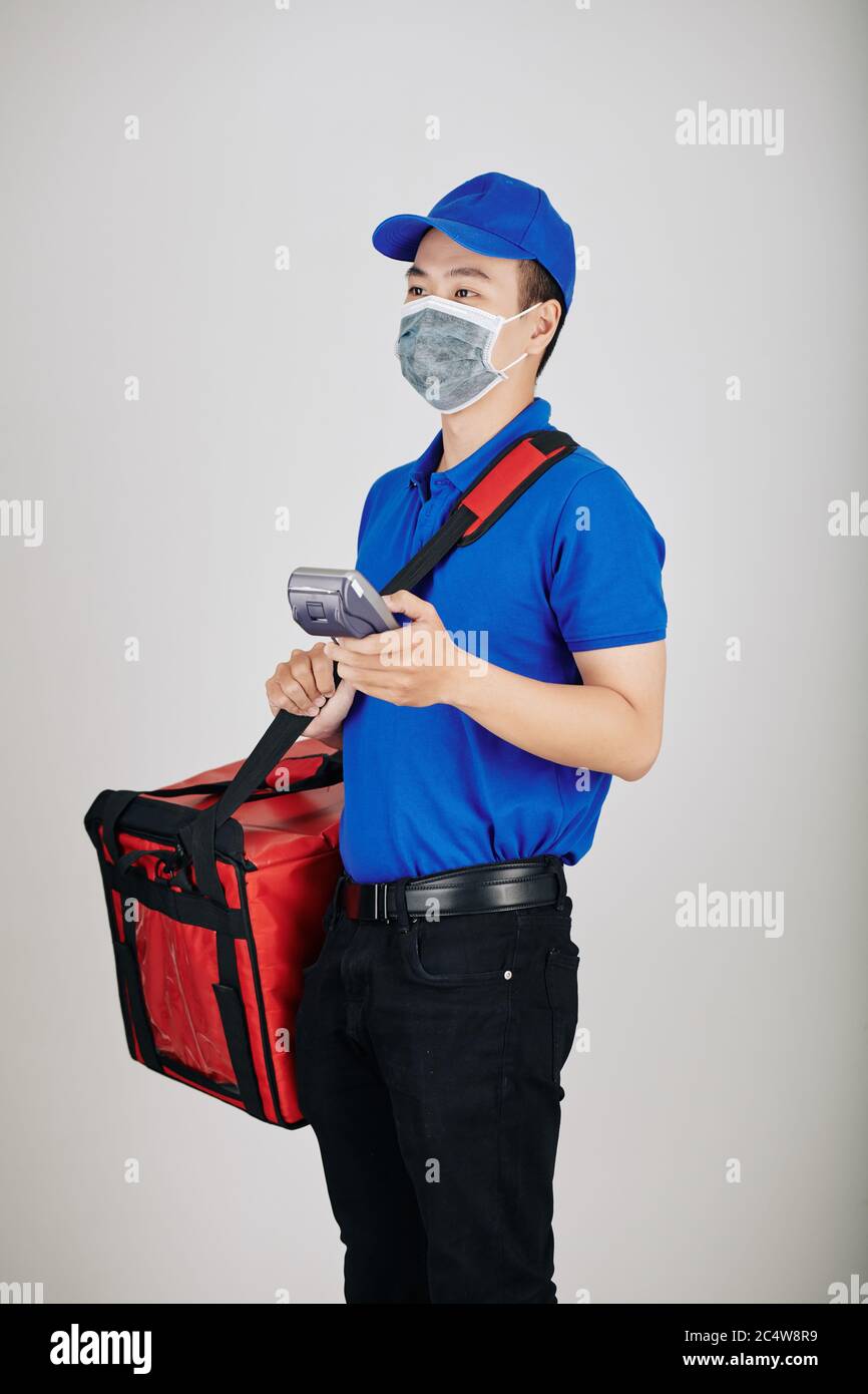 Express delivery service worker in medical mask with big food bag and ...