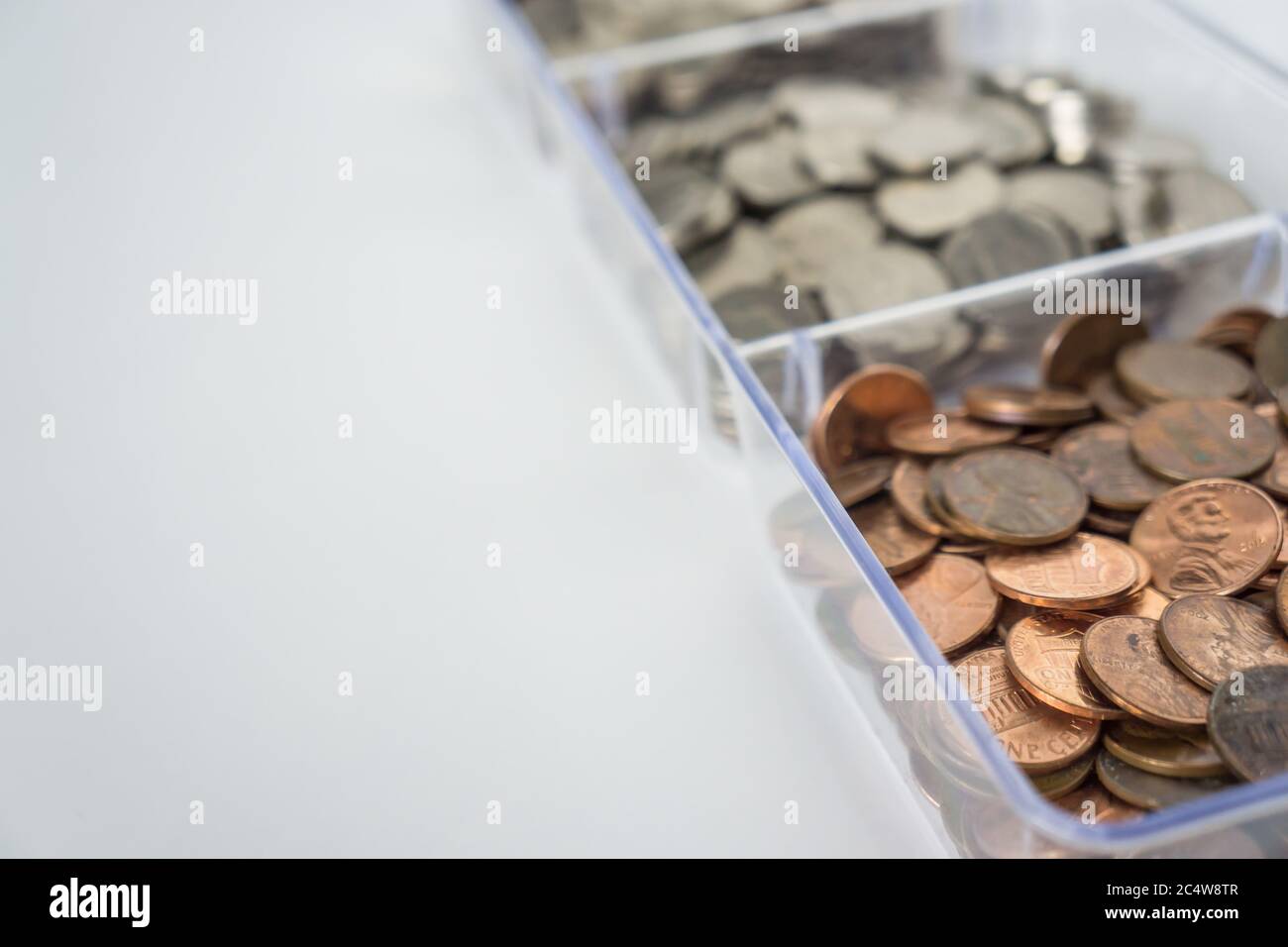 Close up shot of shiny coins separated in a special container Stock ...