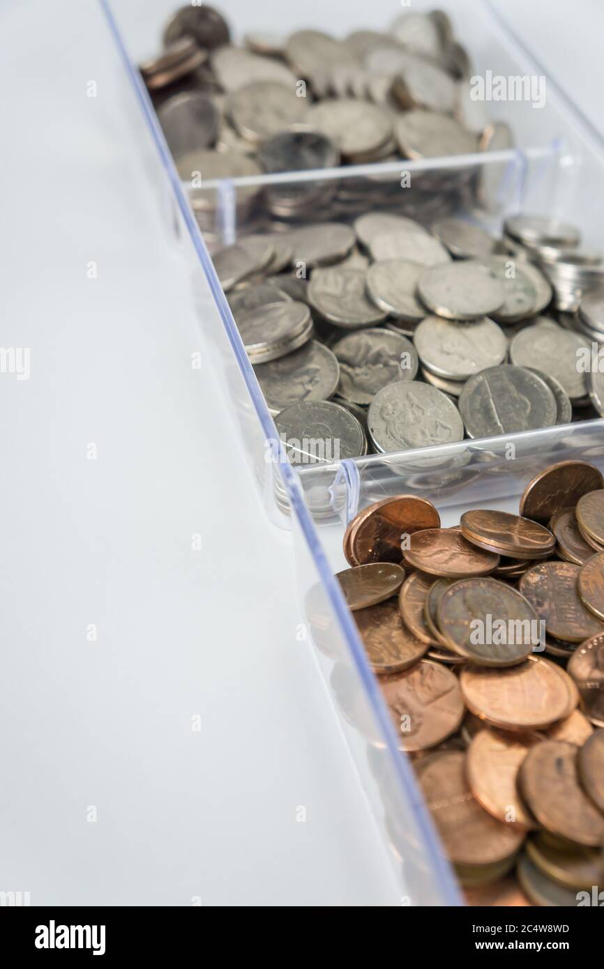 Close up shot of shiny coins separated in a special container Stock ...