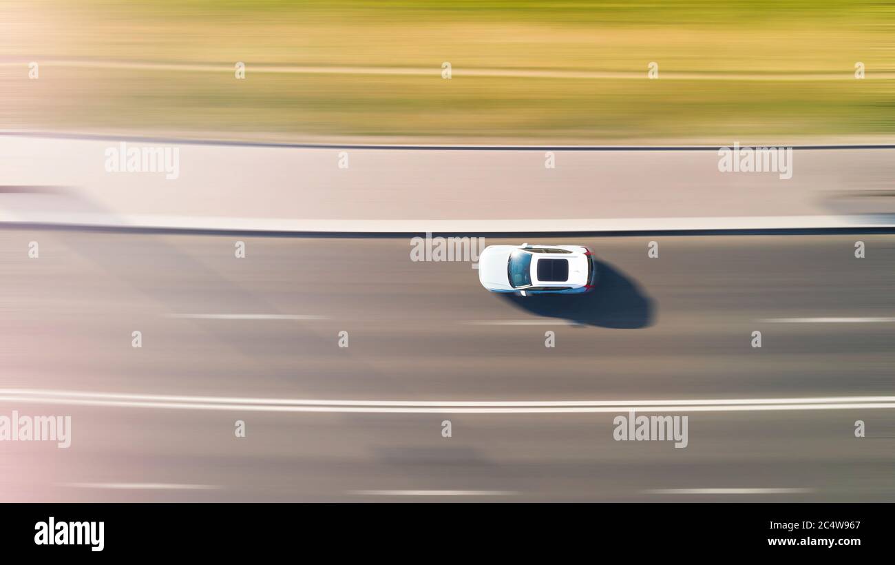 Aerial top down view of the white car moving fast on the road, motion ...