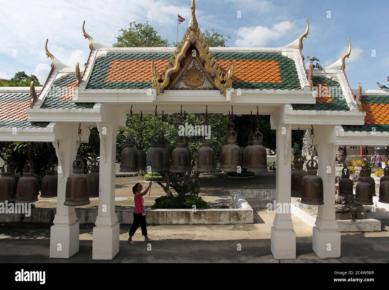 A worshipper touches the bells at Wat Phra Phutthabat Ratchaworamahaviharn known as the “temple ...