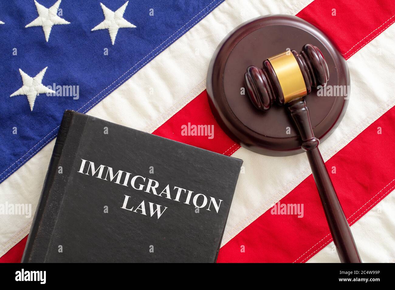 Immigration law text on black book and judge gavel on US of America ...