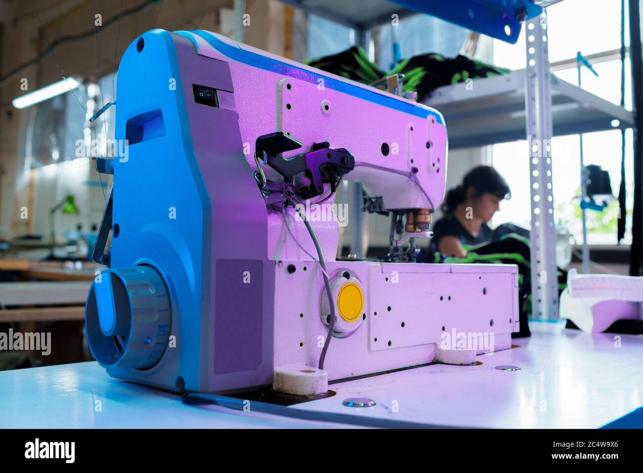 Sewing department of a textile factory interior Stock Photo - Alamy