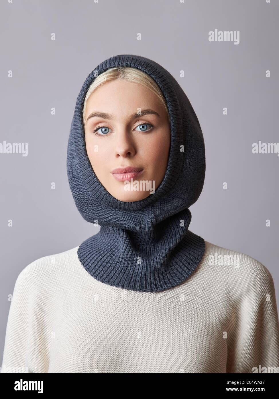 European Muslim woman with a blonde hair in a bonnet hood dressed on ...