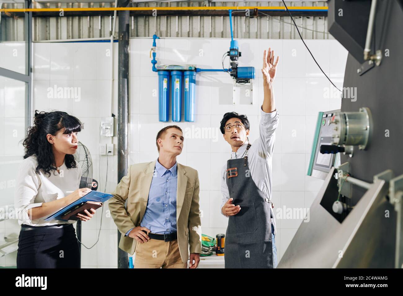 Inspectors checking modern coffee roastery production facility and ...
