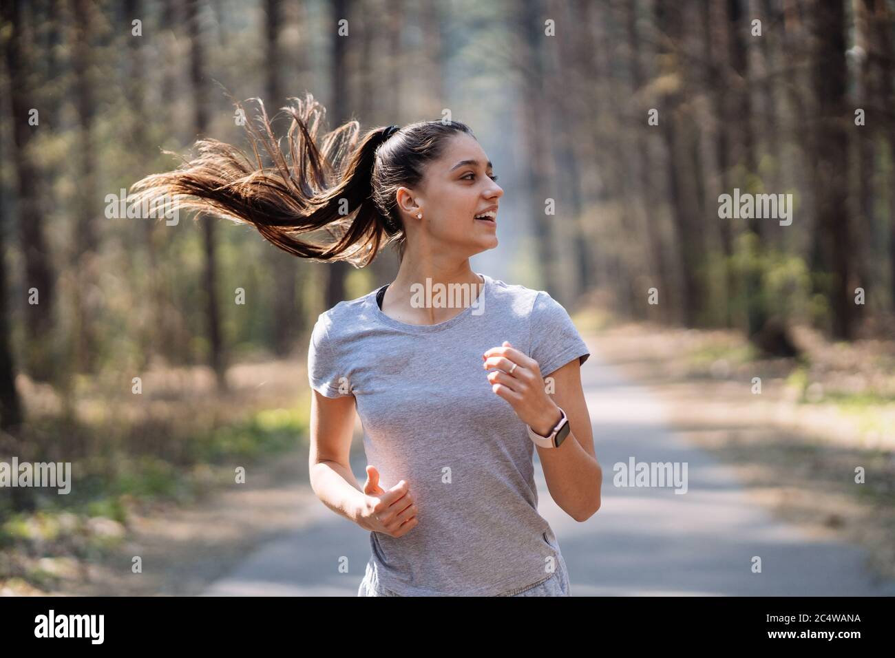 Beautiful teenage sport girl running on the grass active hi-res stock ...
